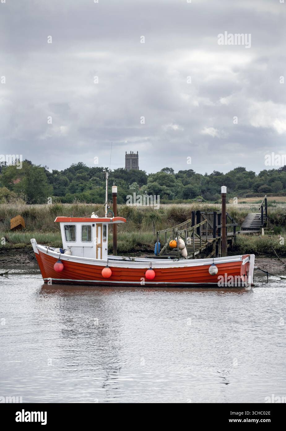 Inshore fishing boat and walberswick church, across river blyth ...