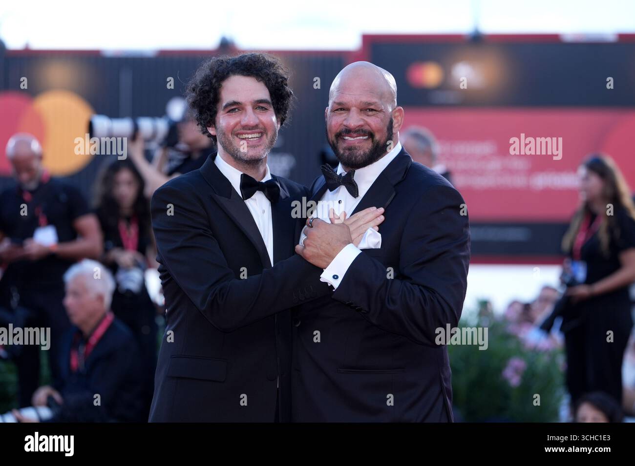 Benny Safdie and Mark Kerr attend "The Smashing Machine" red carpet ...