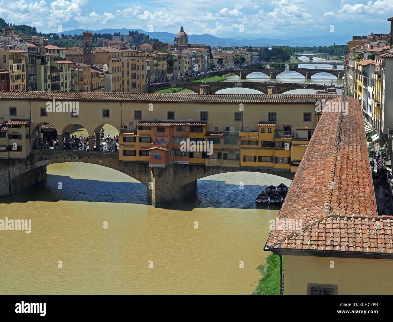 roof level view of the buildings & arches of the Ponte Vecchio ...