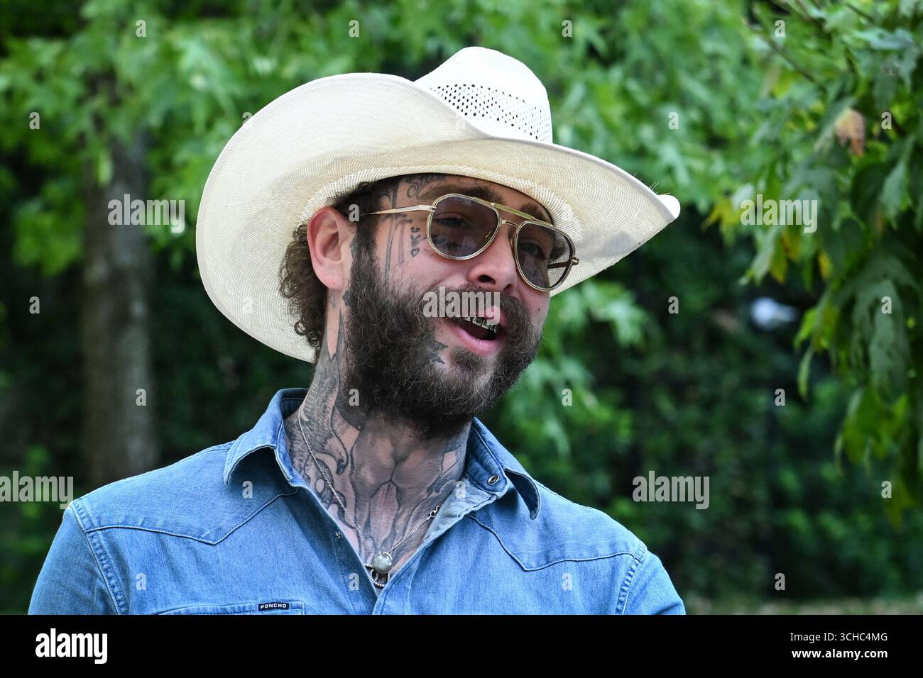 American singer Post Malone walks around as he prepares for a runway ...
