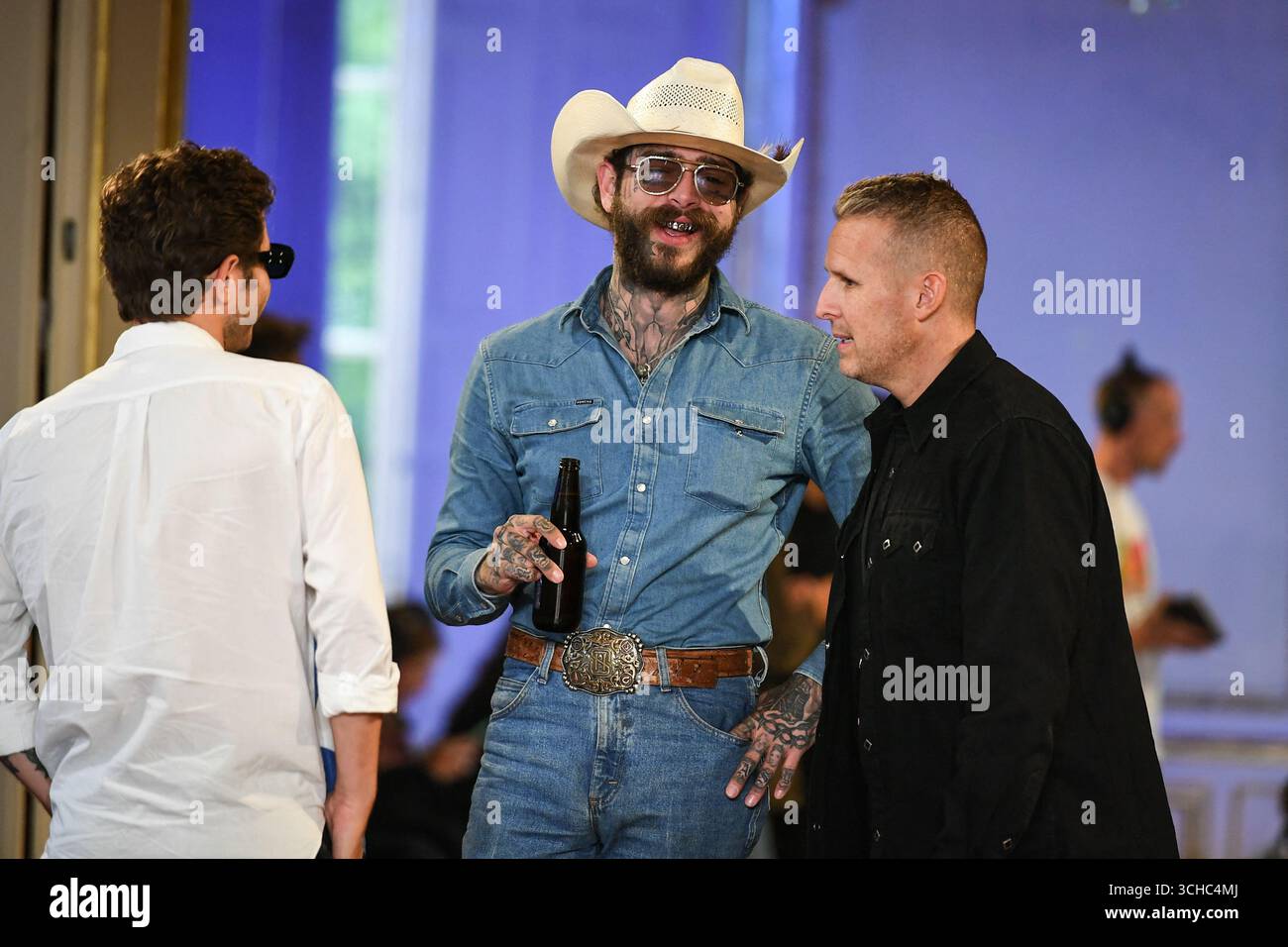 American singer Post Malone walks around as he prepares for a runway ...