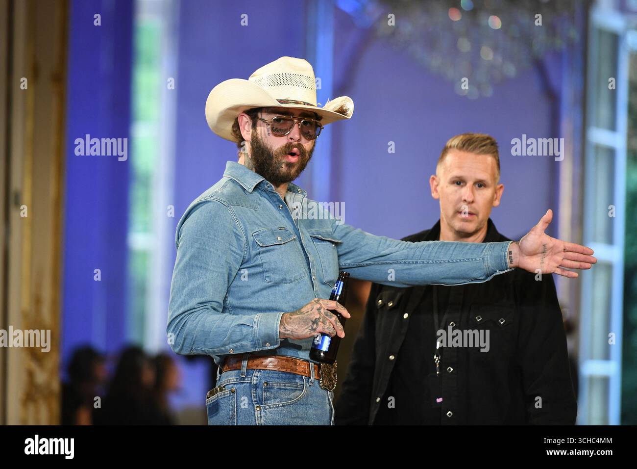 American singer Post Malone walks around as he prepares for a runway ...