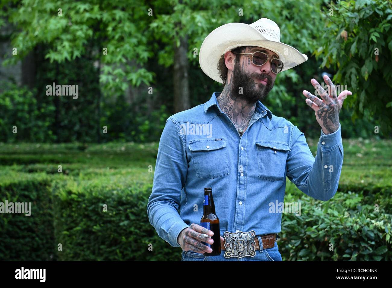 American singer Post Malone walks around as he prepares for a runway ...