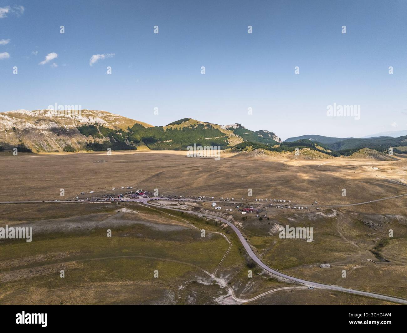 Aerial view of a straight road cutting through the expansive, sun-baked ...