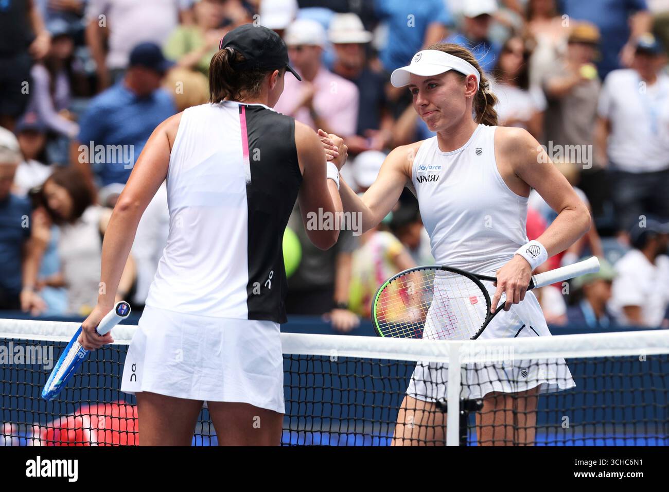 Iga Swiatek, left, of Poland, greets Ekaterina Alexandrova, of Russia, after winning their match ...