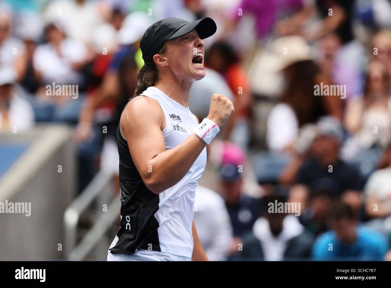 Iga Swiatek, of Poland, reacts after winning a match against Ekaterina Alexandrova, of Russia ...