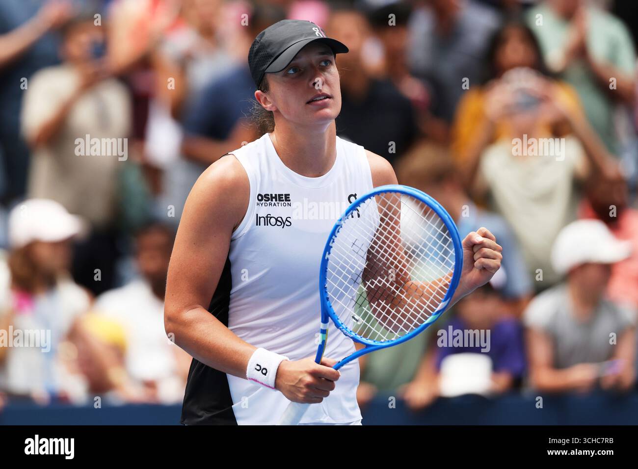 Iga Swiatek, of Poland, reacts after winning a match against Ekaterina Alexandrova, of Russia ...