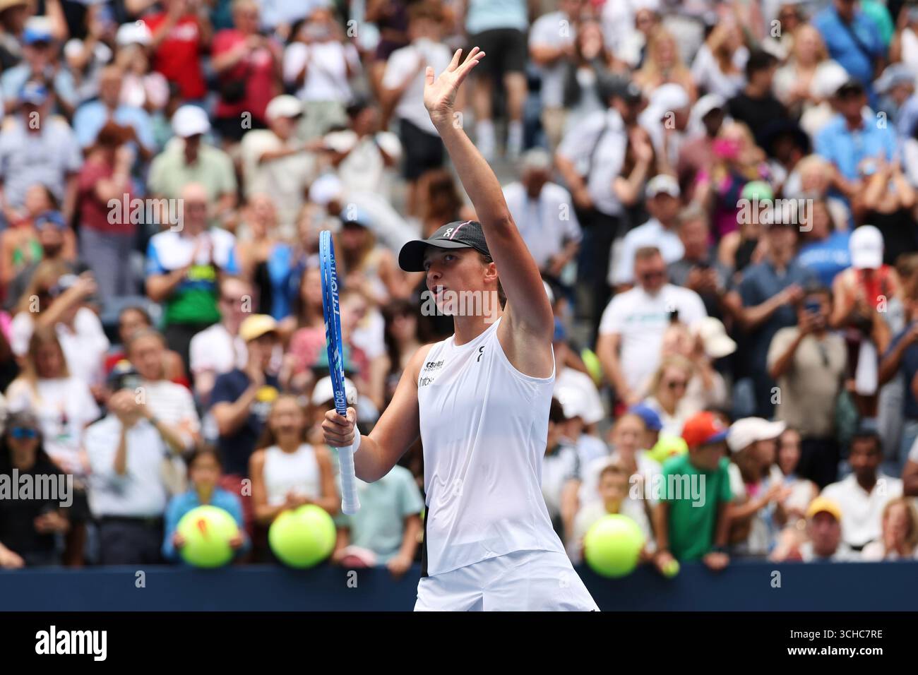 Iga Swiatek, of Poland, reacts after winning a match against Ekaterina Alexandrova, of Russia ...