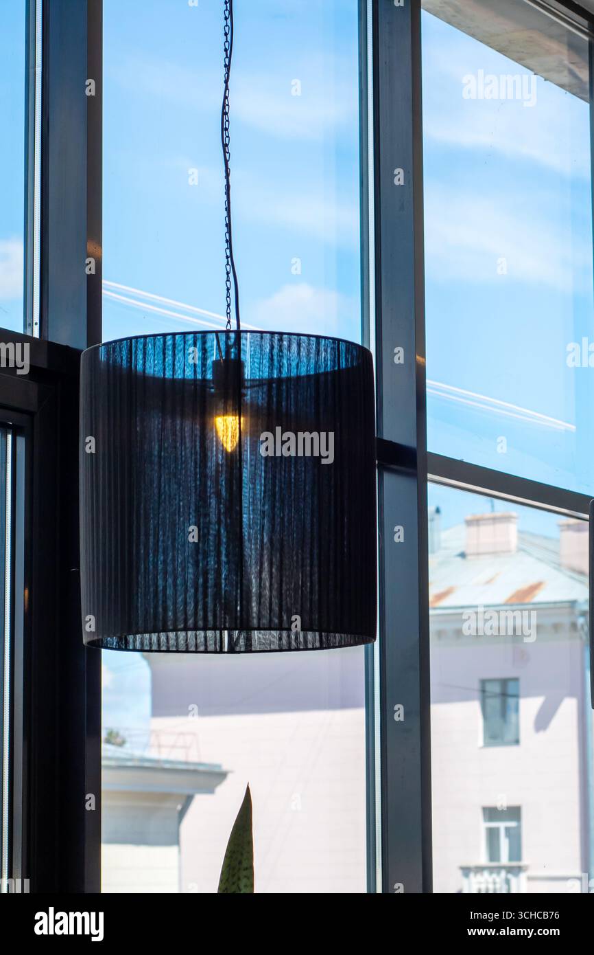 A contemporary pendant light hangs elegantly, featuring a stylish shade ...