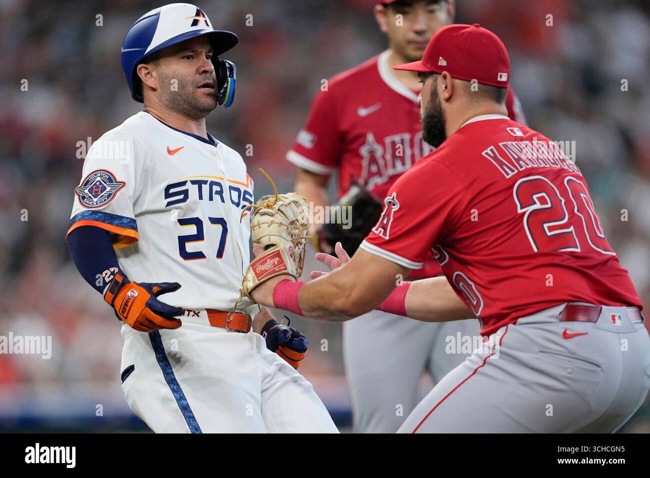 Houston Astros' Jose Altuve (27) is tagged out by Los Angeles Angels ...