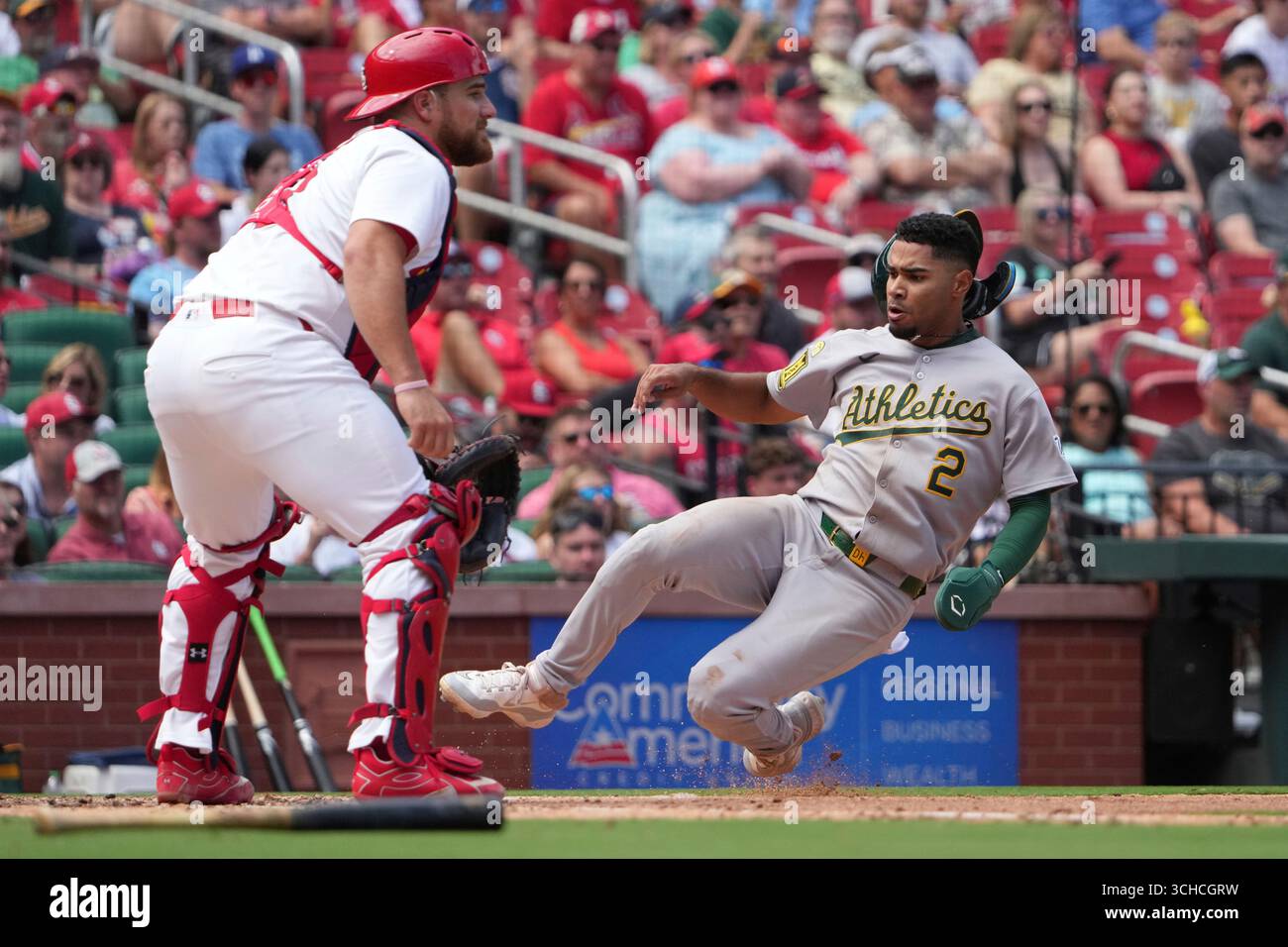 Athletics' Darell Hernaiz (2) scores past St. Louis Cardinals catcher ...