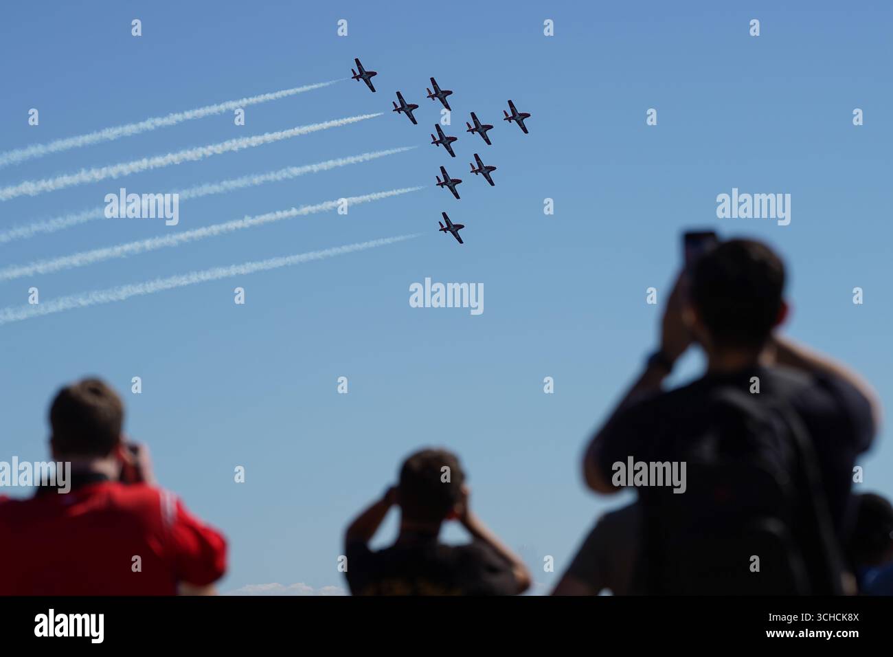 Spectators watches from the Toronto waterfront, their eyes fixed on the ...