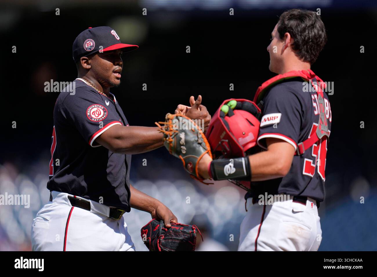 Washington Nationals relief pitcher Jose Ferrer, left, shakes hands ...