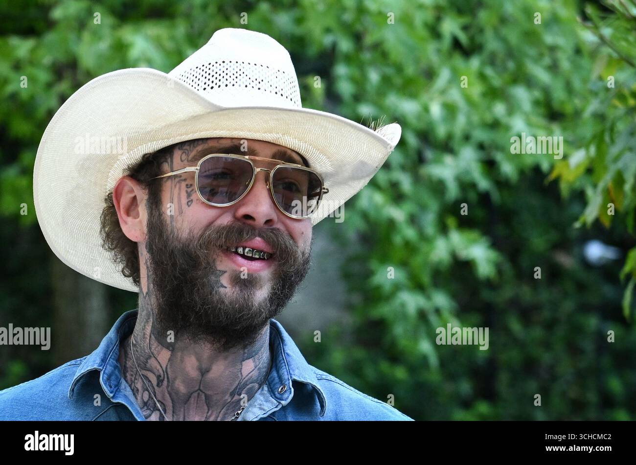 American singer Post Malone walks around as he prepares for a runway ...