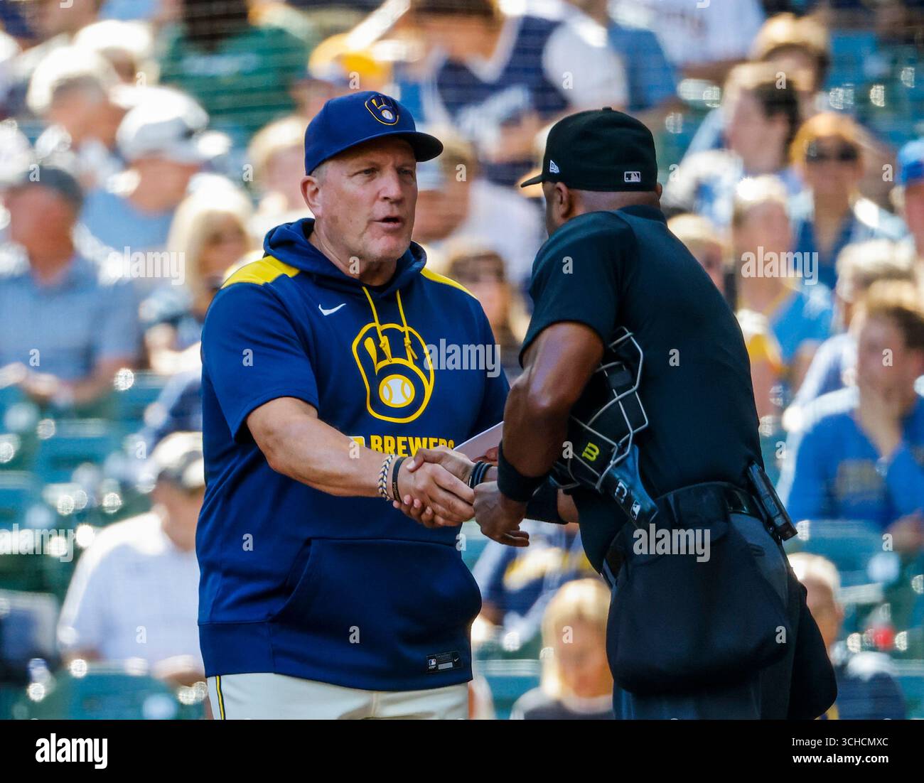 Milwaukee Brewers manager Pat Murphy greets home plate umpire Alan ...