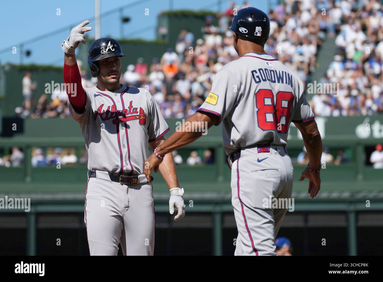 Atlanta Braves' Matt Olson, left, celebrates with first base coach Tom ...
