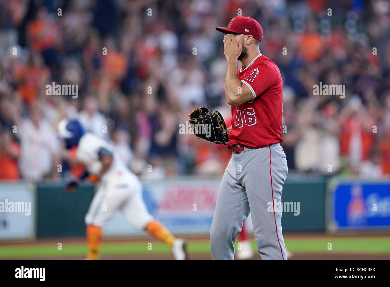 Los Angeles Angels pitcher Brock Burke (46) wipes his face after giving ...
