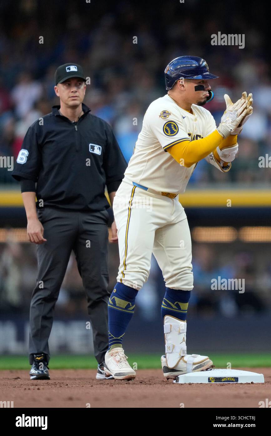 Milwaukee Brewers' William Contreras, right, reacts after hitting a ...