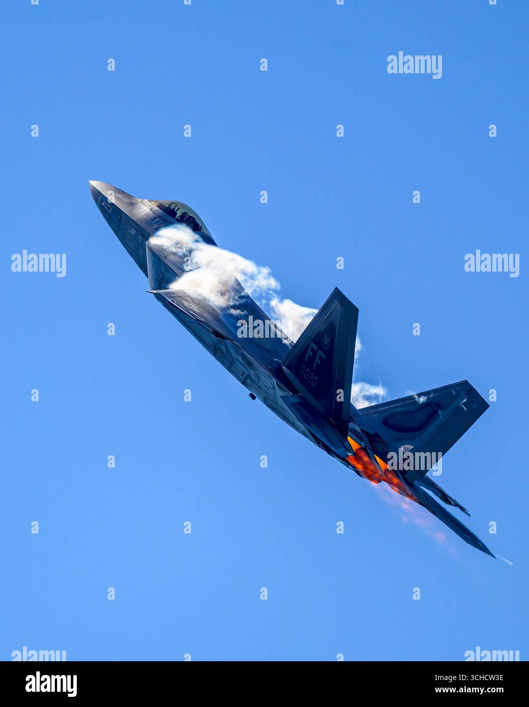 F-22 Raptor close up in flight climbing with afterburners and vapor ...