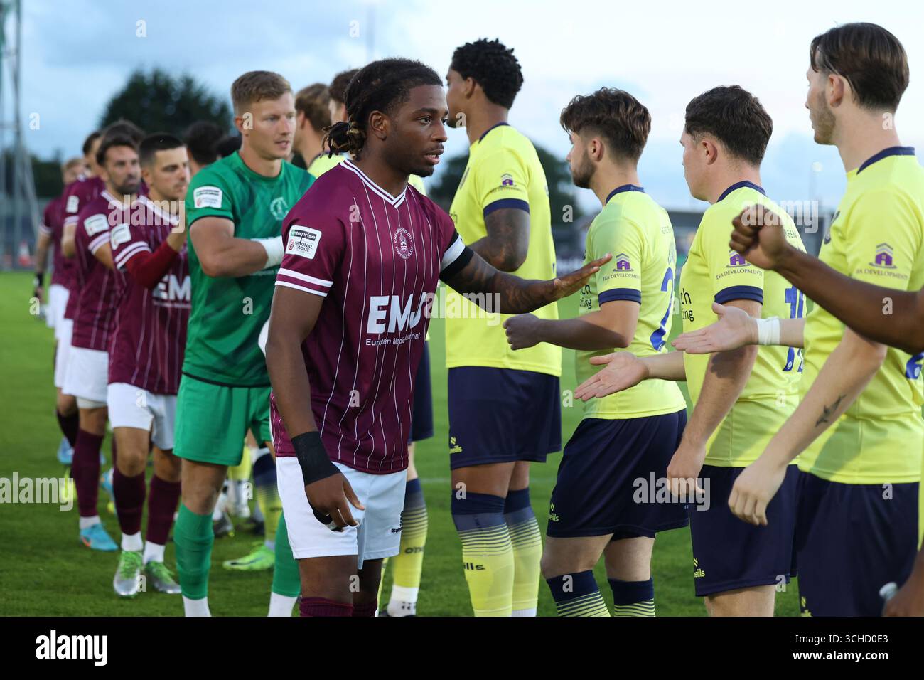Dom Odusanya, of Chelmsford City, shakes hands with Fanborough players ...