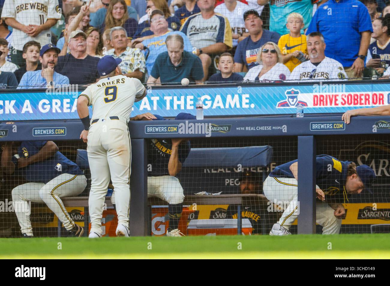 Milwaukee Brewers players duck from a foul ball hit by Philadelphia ...