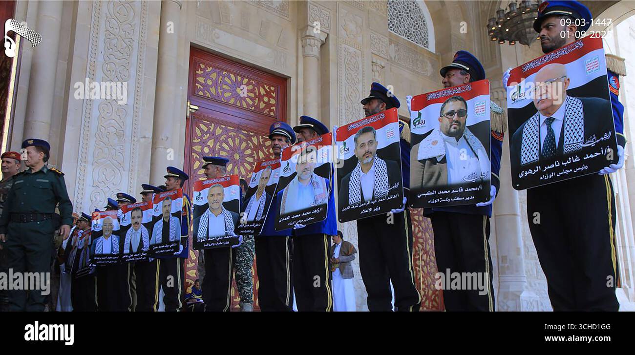 Yemeni honor guard carry portraits of Prime Minister of Yemen's Houthi ...