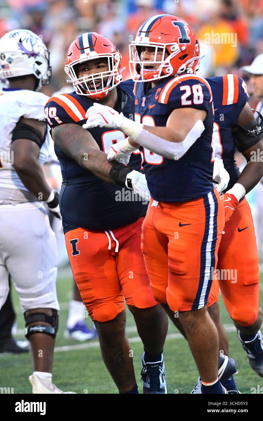 CHAMPAIGN, IL - AUGUST 29: Illinois linebacker Curtis Neal (99) and Illinois middle linebacker ...
