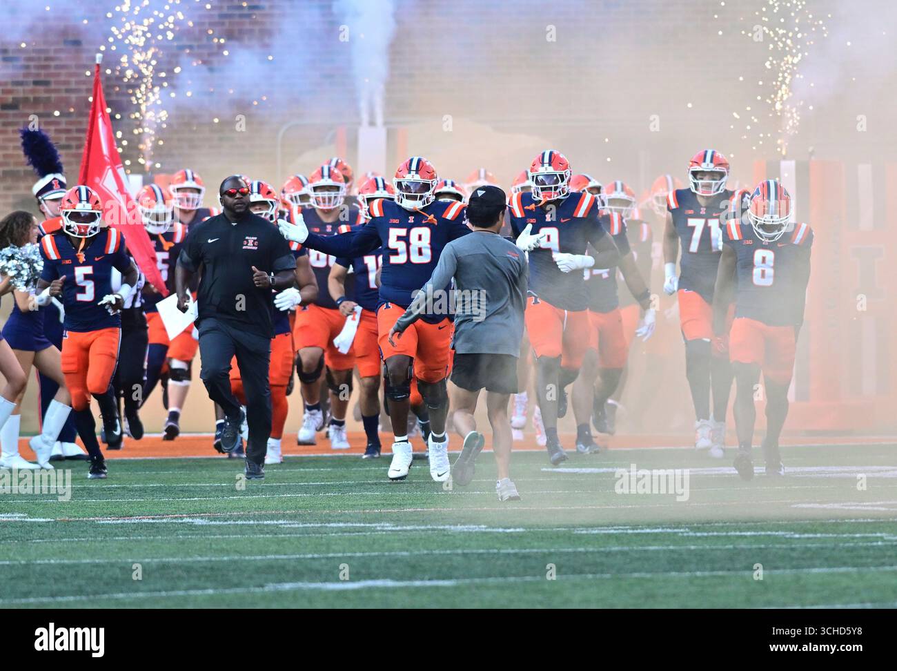 CHAMPAIGN, IL - AUGUST 29: Members of the Illinois football team take ...