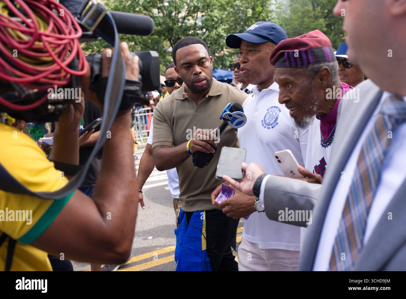 A news reporter interviews a group of men, including a politician, in ...