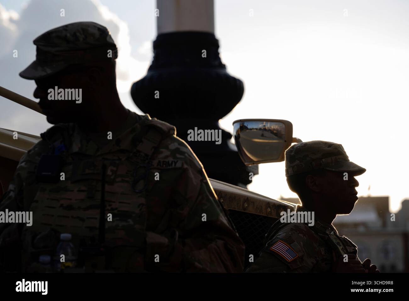 Members of the DC National Guard stand next to a Mine Resistant Ambush ...