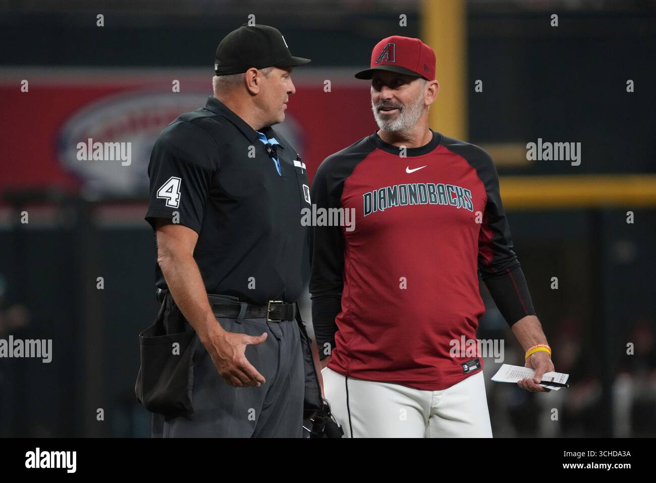 MLB umpire Chad Fairchild (4) talks to Arizona Diamondbacks manager ...