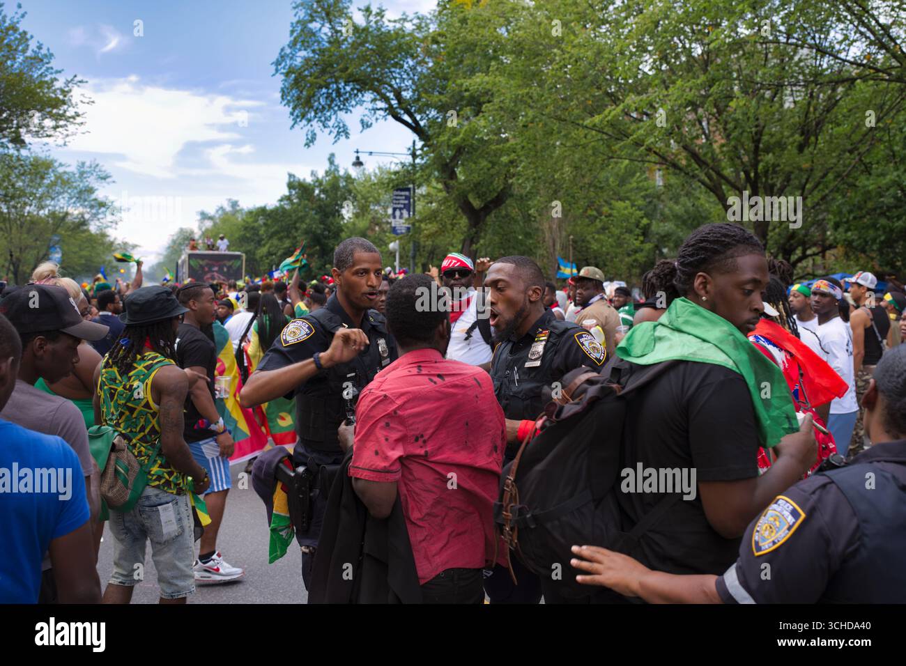 Police officers engage with a crowd during a vibrant street festival ...