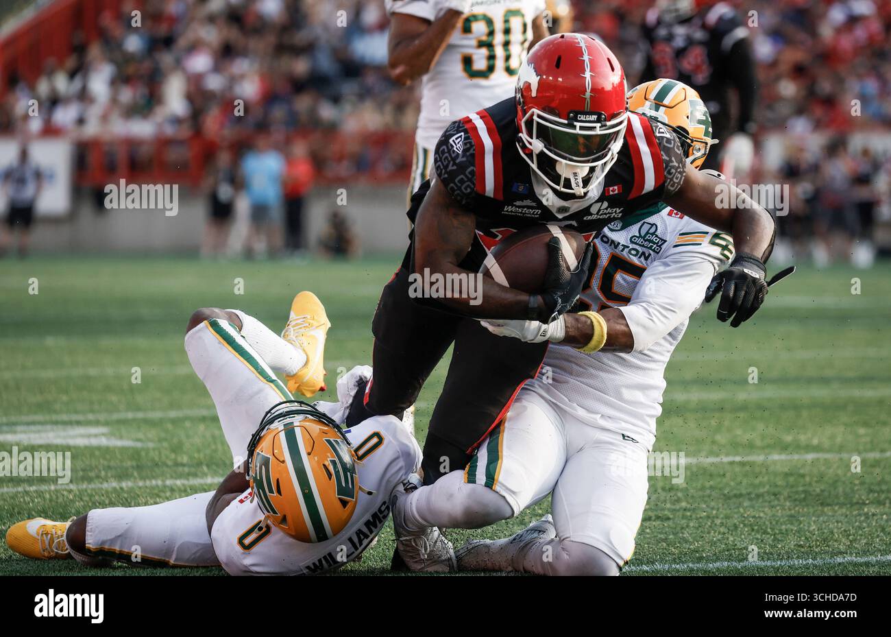 Edmonton Elks' Chelen Garnes, right, and Kobe Williams, left, tackle ...