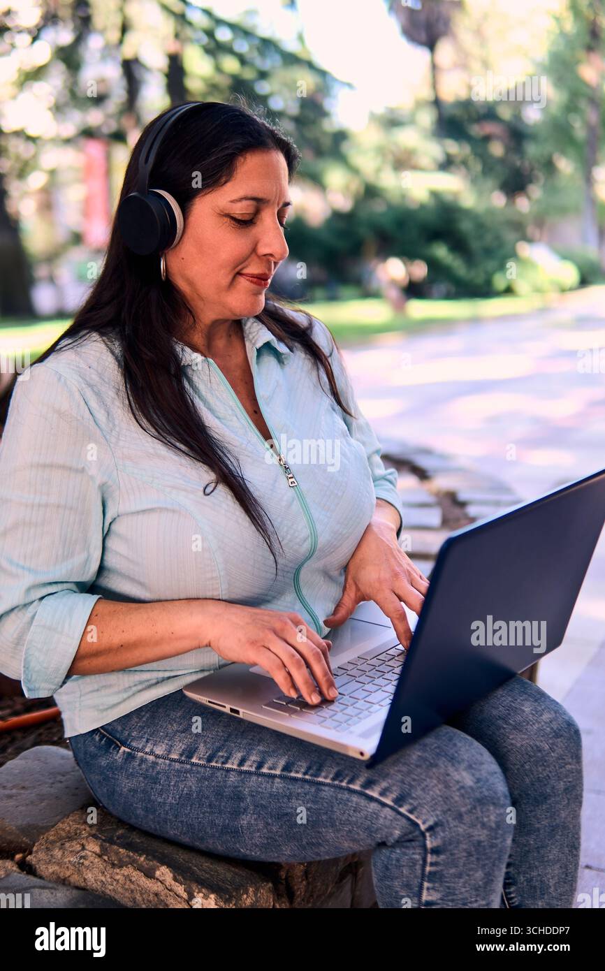 Beautiful Adult Latina Professional Working Online Wearing Headphones