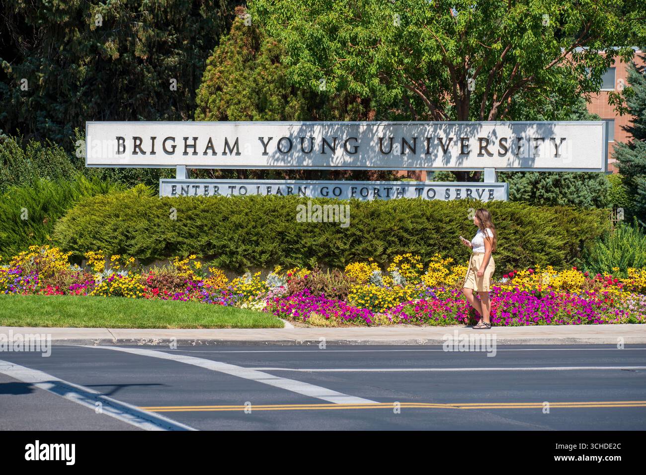 Provo, Utah – September 1, 2025: A woman passes the entrance to Brigham ...