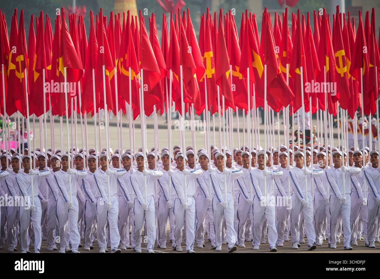 Vietnamese march with the national flag during a military parade ...