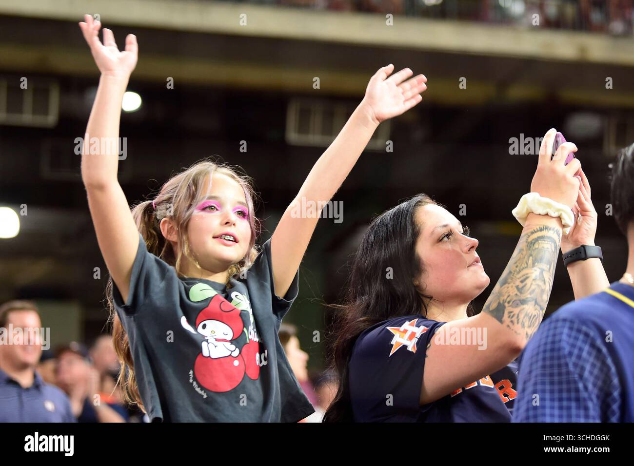 Fans sing during the seventh inning stretch during an MLB game between ...