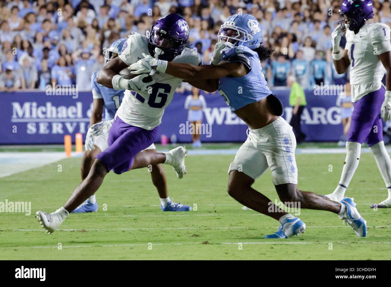 TCU running back Jeremy Payne, left, tries to avoid a tackle by North ...