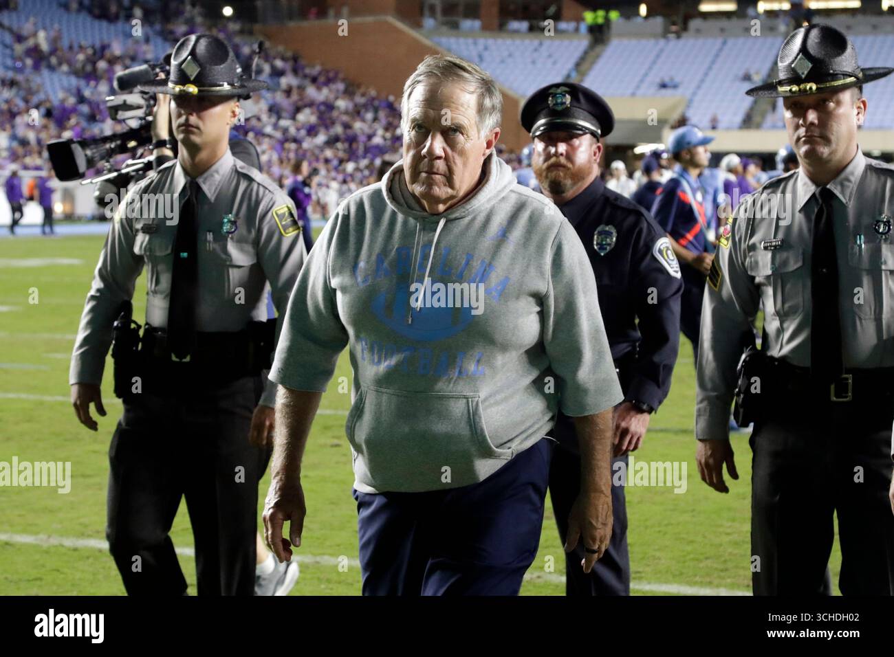 North Carolina head coach Bill Belichick, front, walks off the field ...