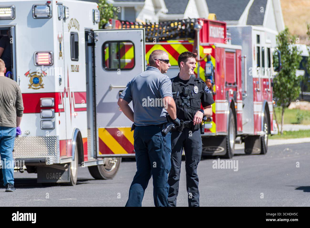 Santaquin, Utah — Sept 1, 2025: Two police officers confer beside a ...