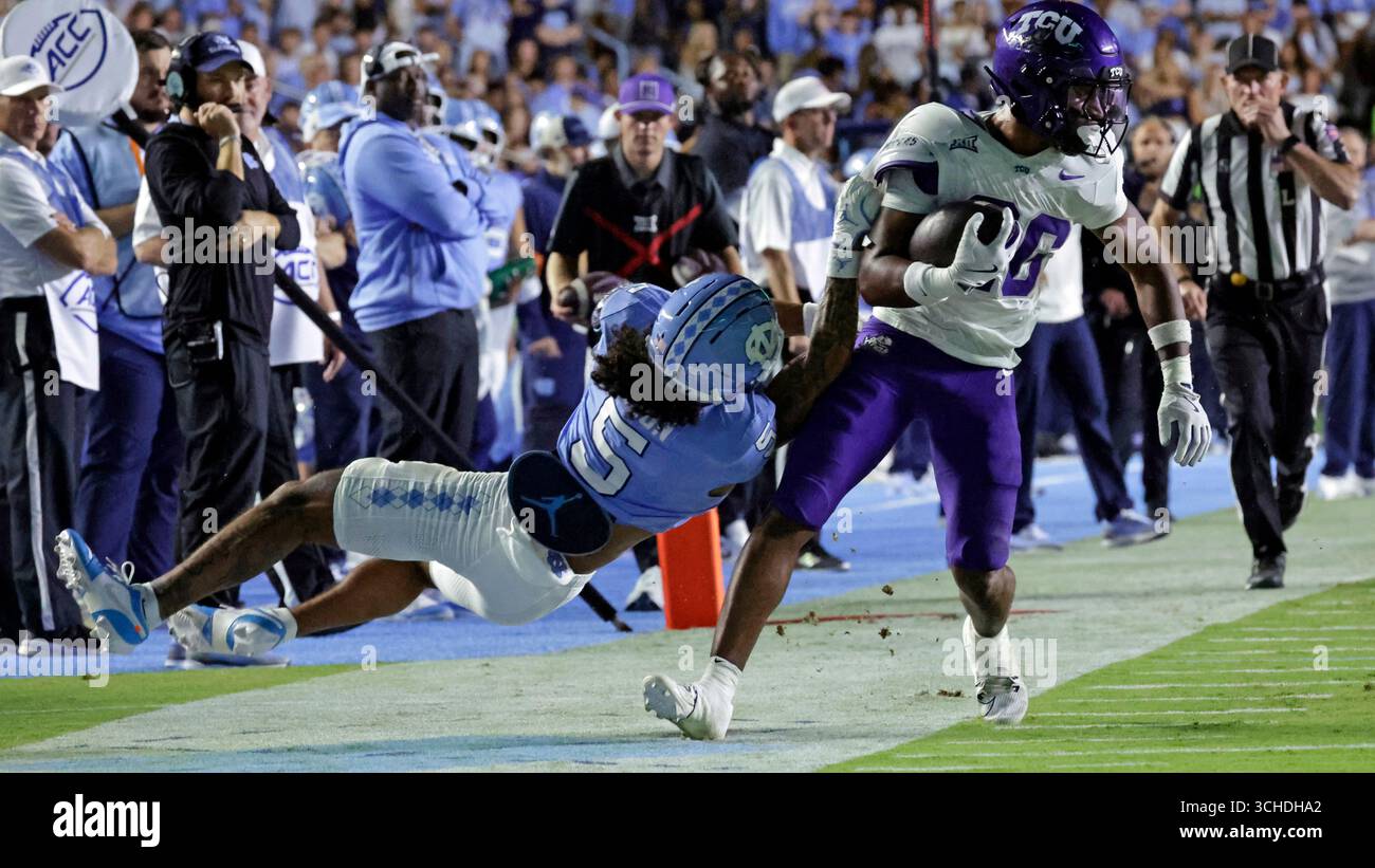 TCU running back Jeremy Payne, front right, is dragged out of bounds by ...