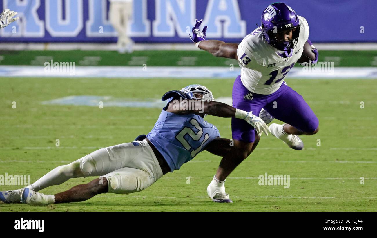 TCU running back Jon Denman (13) tries to evade a tackle by North ...