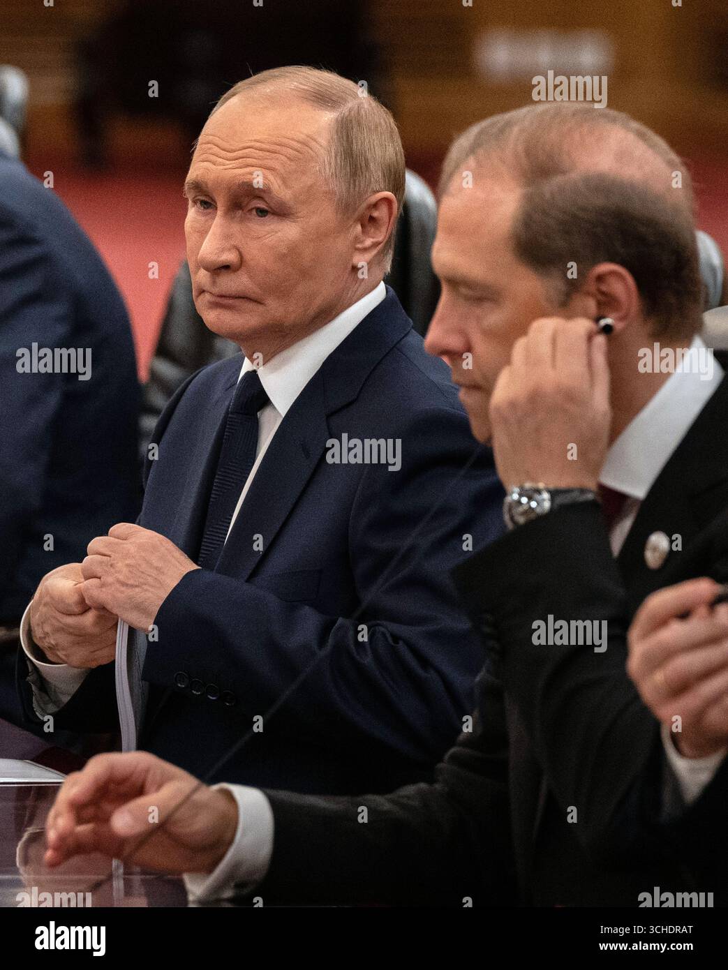 Russian President Vladimir Putin, left, listens at the beginning of a ...