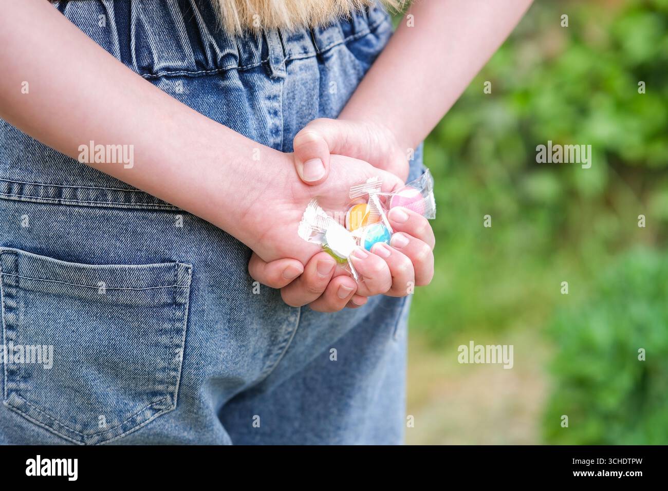 Child hides behind hands hi-res stock photography and images - Alamy