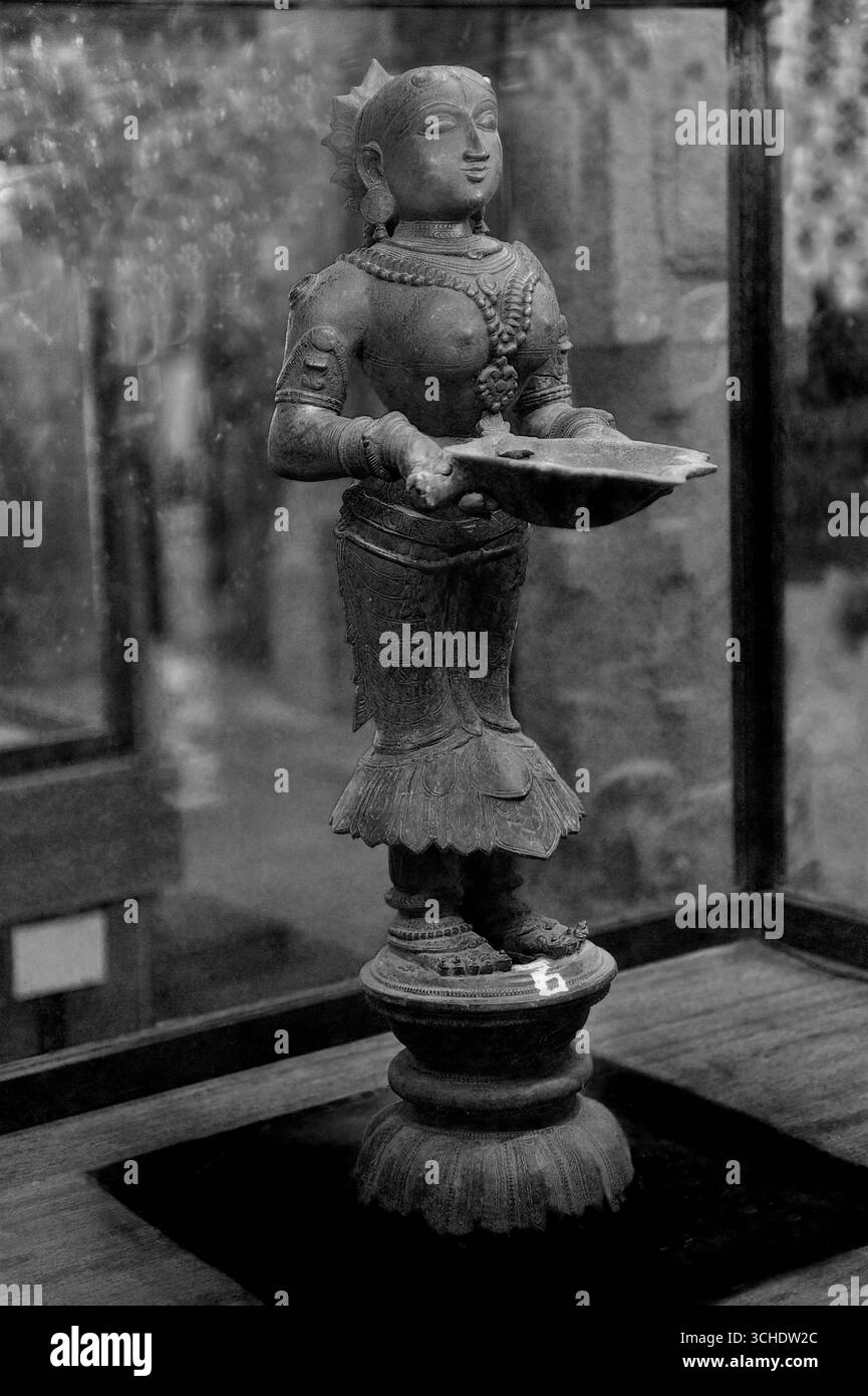 Black and white photo of a statue woman with oil lamp in bronze of ...
