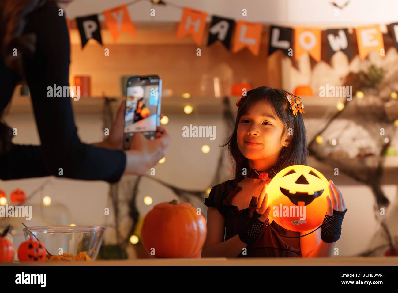 Halloween Joy: Girl Posing with Pumpkin for Photo Stock Photo - Alamy