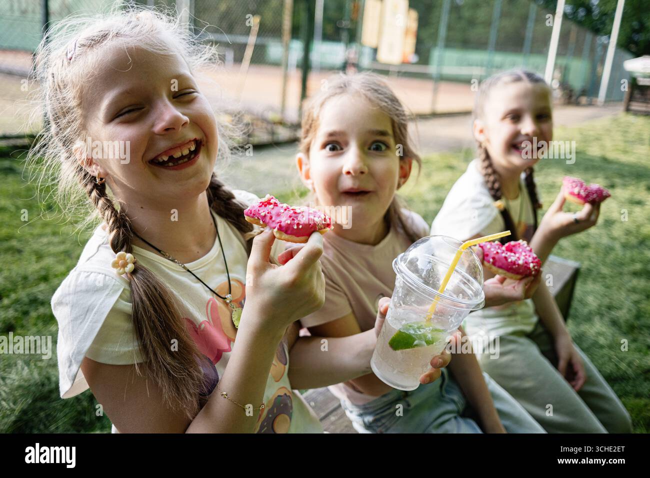 Happy children with desserts and drinks having fun and playing outside ...