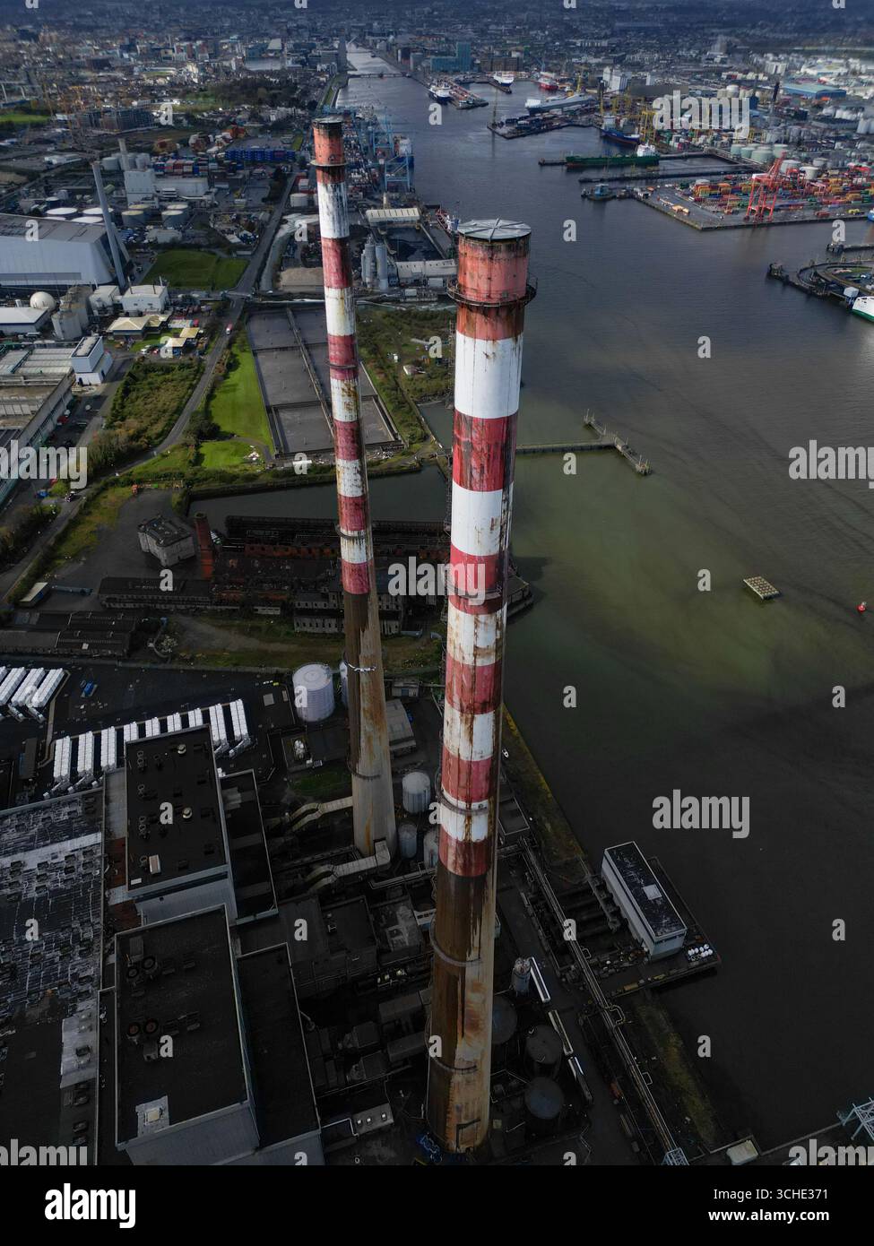 Aerial view of the iconic Poolbeg chimneys stand tall against the muted ...