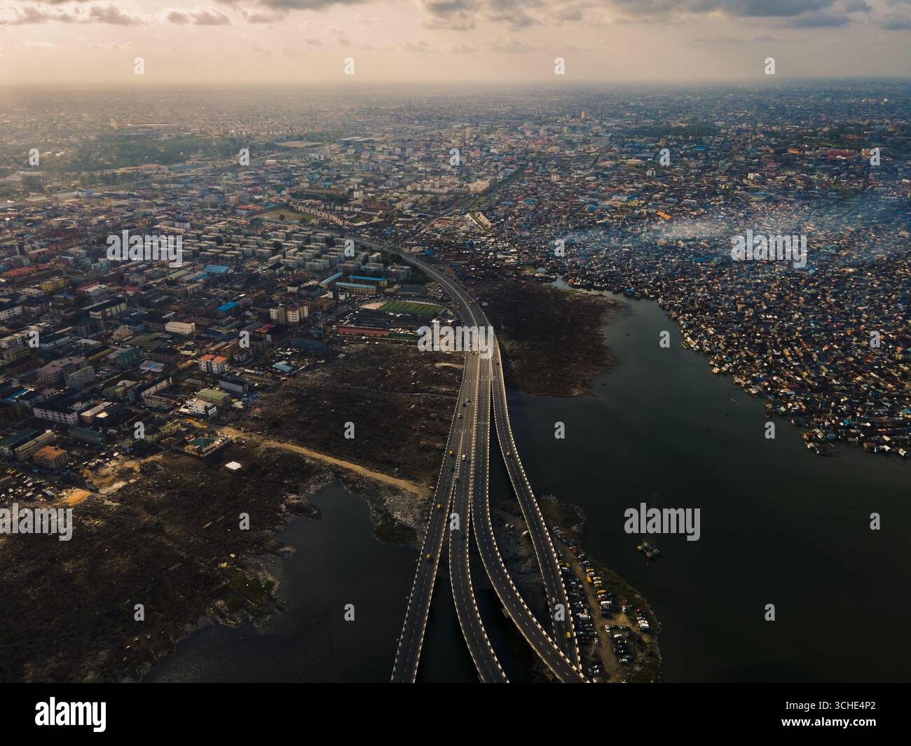 Aerial view of a sprawling cityscape bisected by a dark river and a ...