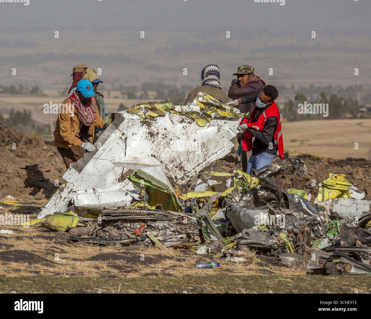 FILE - Workers recover debris at the scene of an Ethiopian Airlines ...